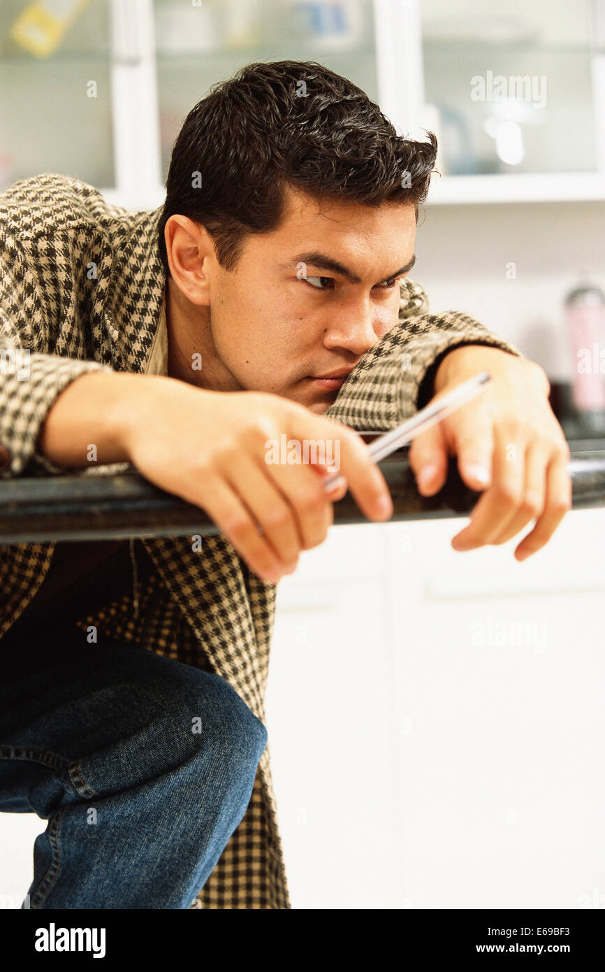 Bored man laying on counter top Stock Photo - Alamy