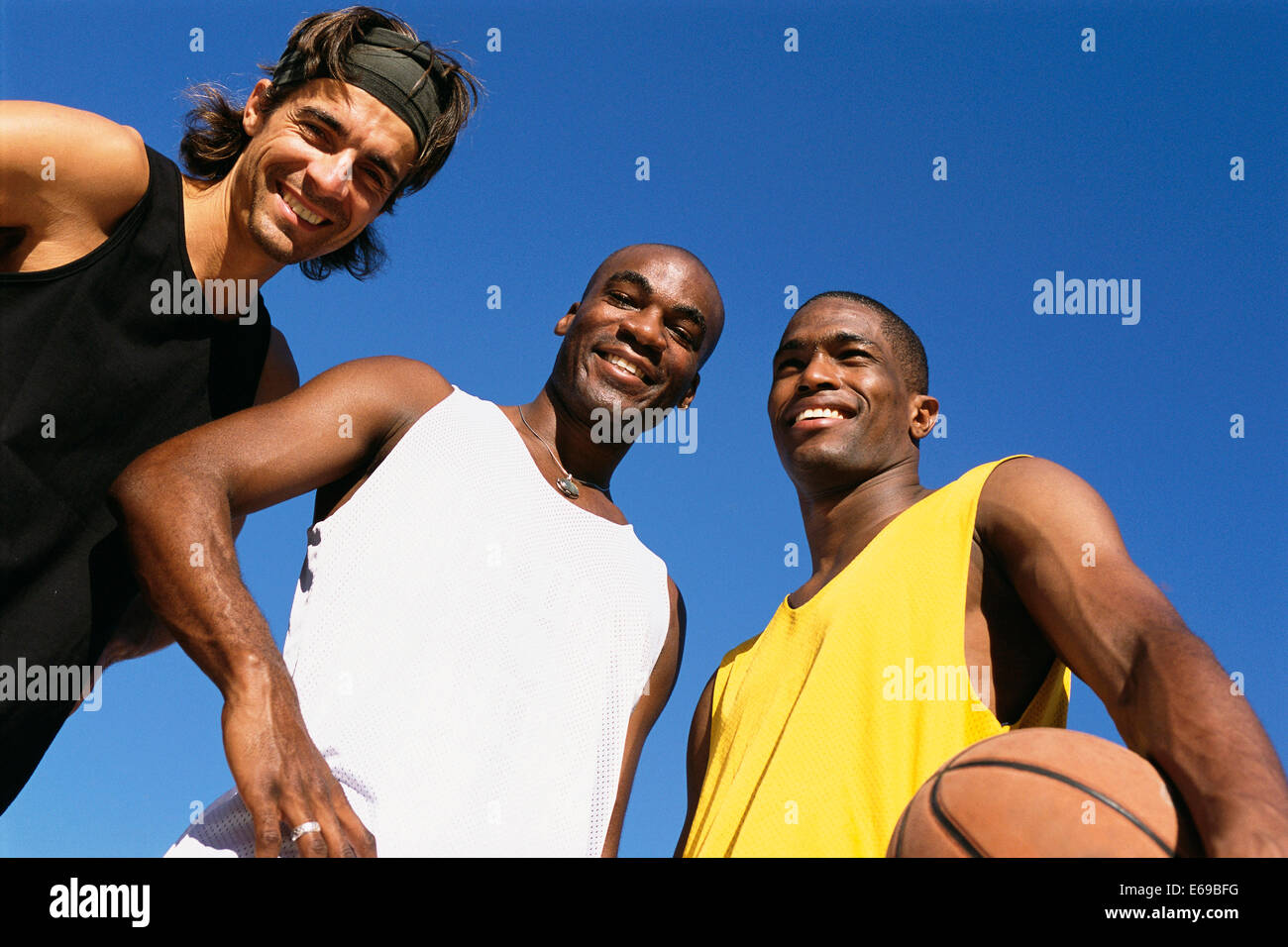 Men smiling on basketball court Stock Photo - Alamy