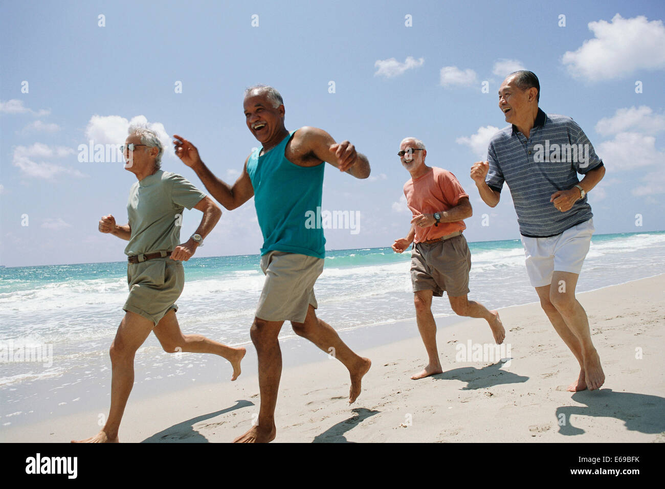 Smiling couple jogging on beach hi-res stock photography and images - Alamy