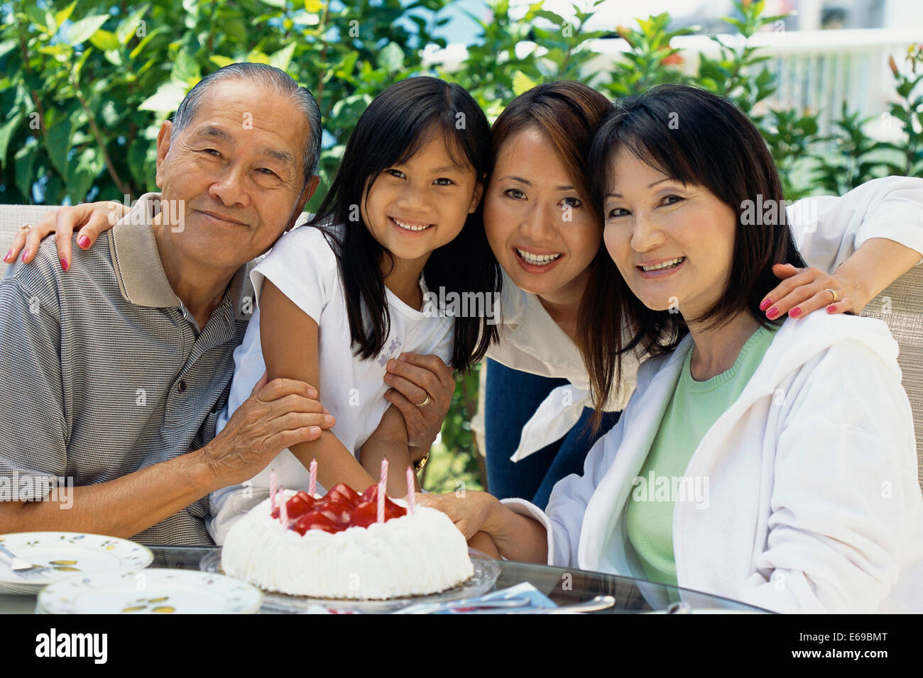 Family smiling together at birthday Stock Photo - Alamy