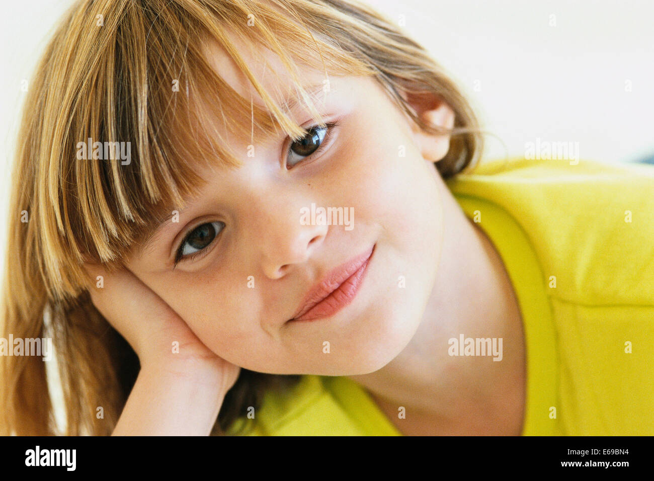 Girl resting head on hand Stock Photo - Alamy