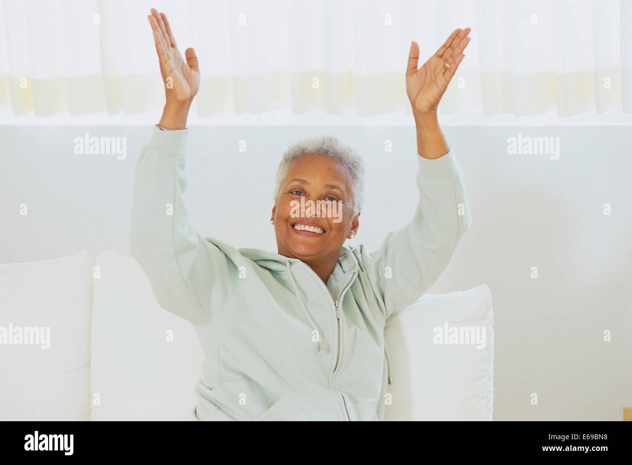 Senior woman clapping her hands Stock Photo - Alamy