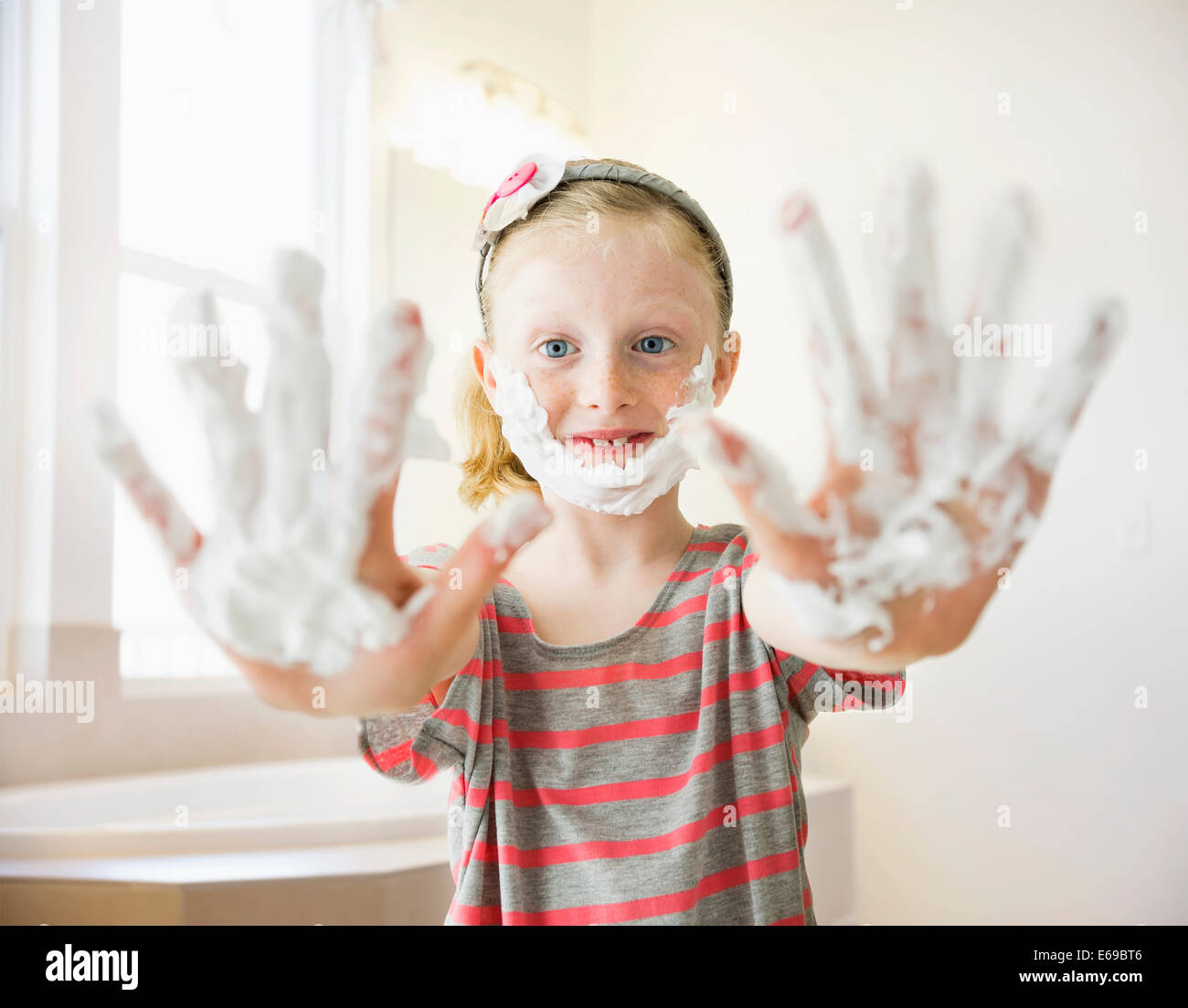 Caucasian girl playing with shaving cream Stock Photo - Alamy