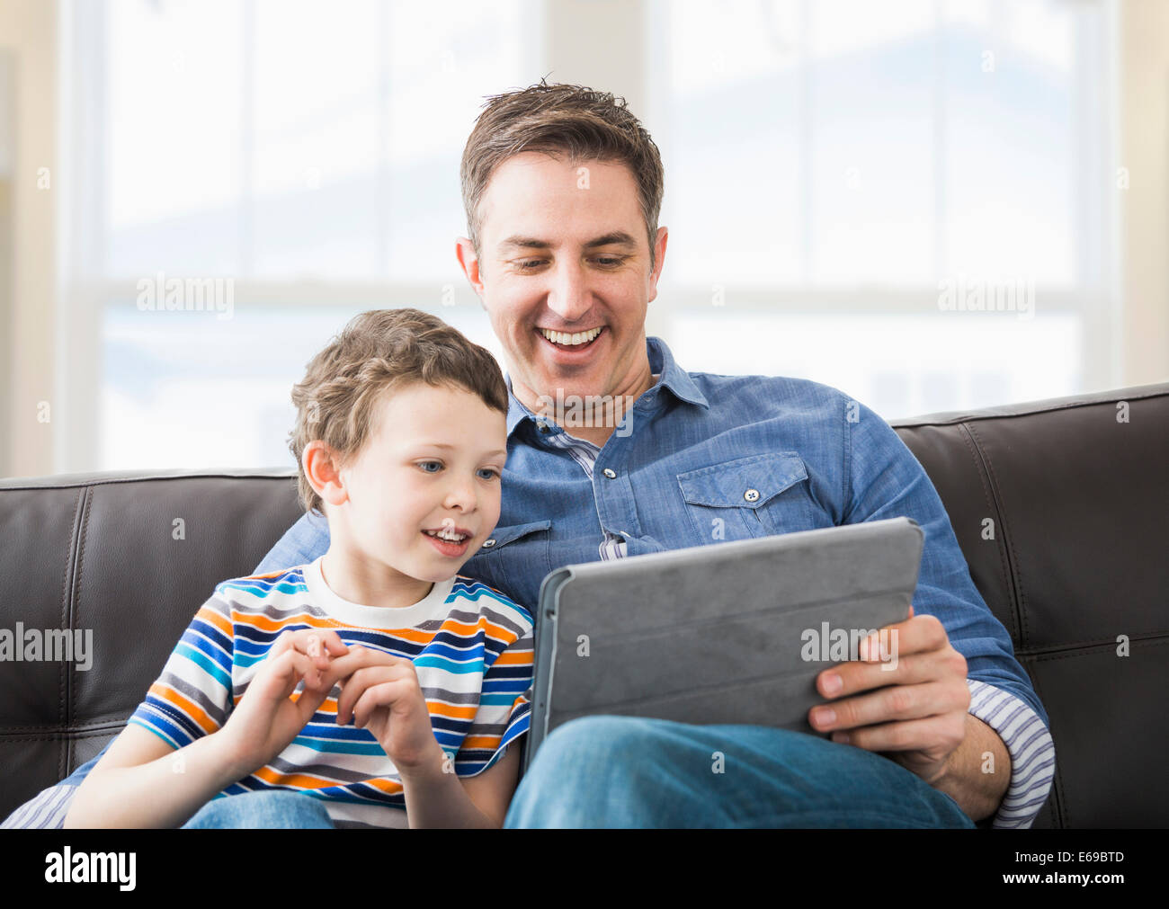 Caucasian father and son using tablet computer Stock Photo - Alamy