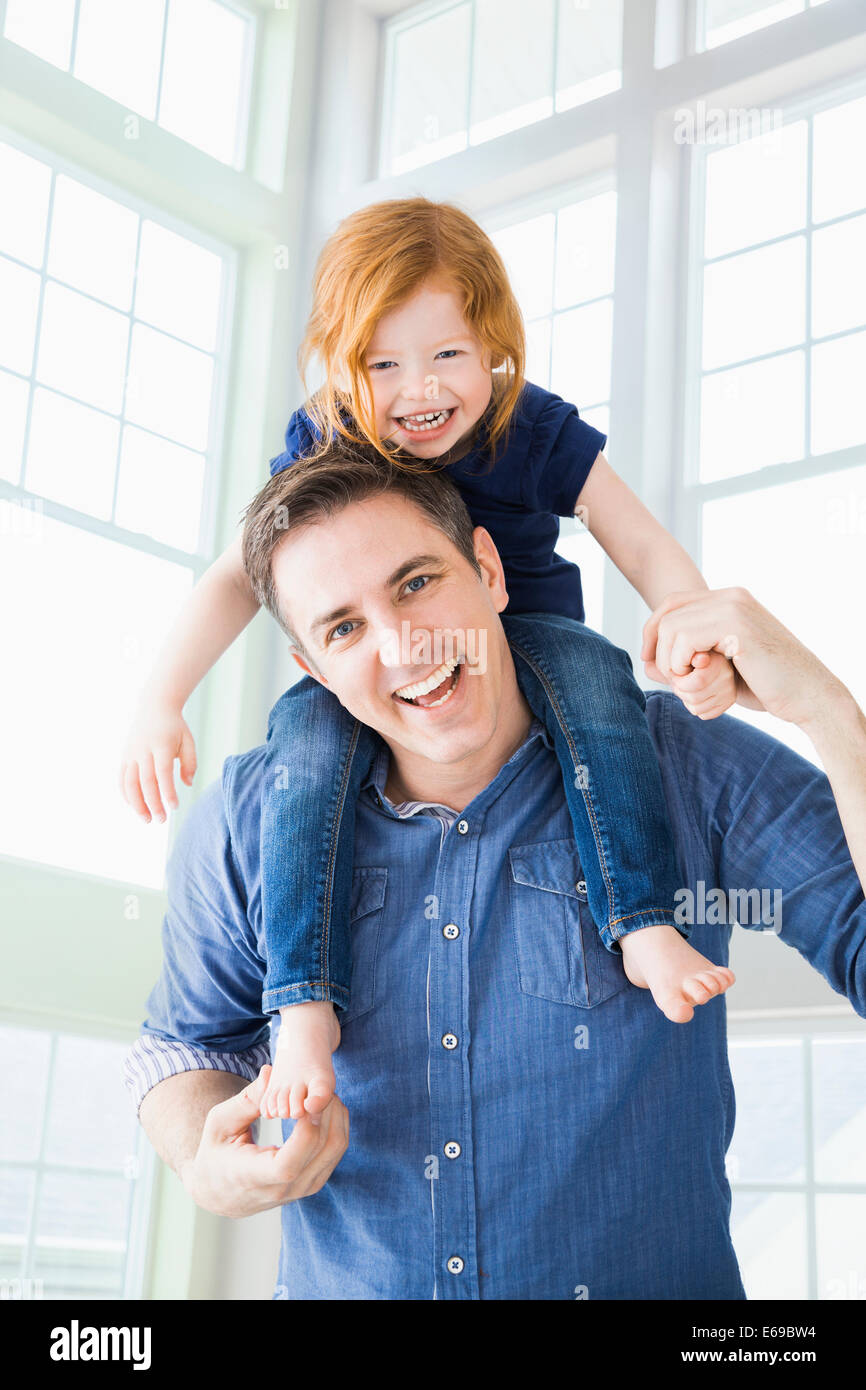 Caucasian father carrying daughter on shoulders Stock Photo - Alamy