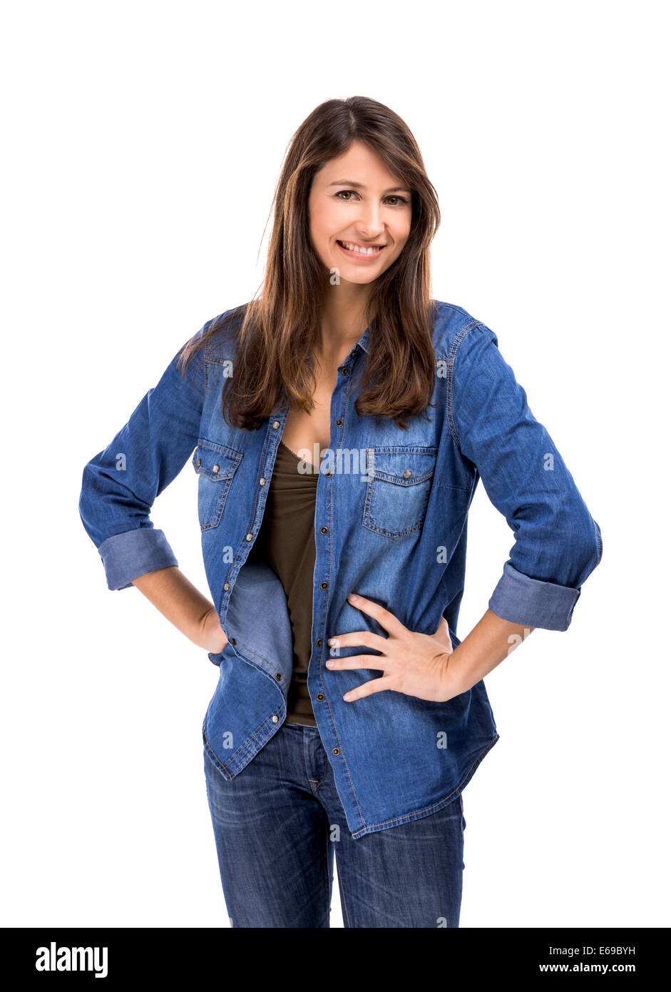 Beautiful woman standing over a white background with hands on the hips ...