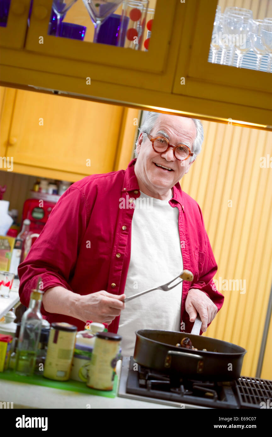 Senior man cooking in kitchen Stock Photo - Alamy