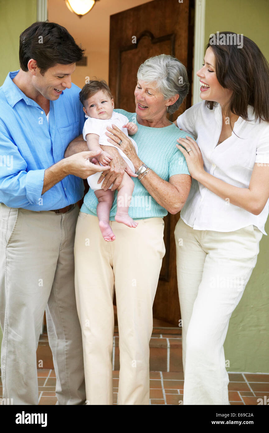 Family smiling together at front door Stock Photo - Alamy