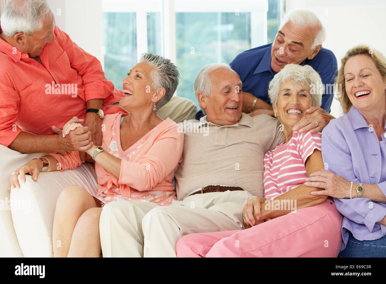 Senior friends talking in living room Stock Photo - Alamy