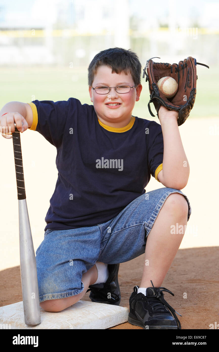 Boy holding baseball with mitt and bat Stock Photo - Alamy