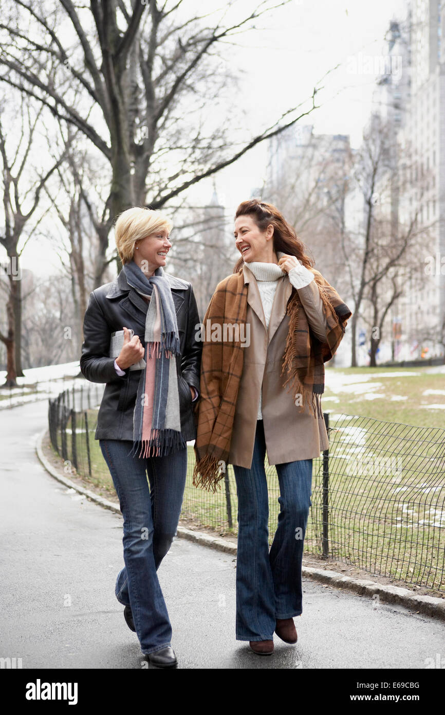 Women walking together in urban park Stock Photo - Alamy