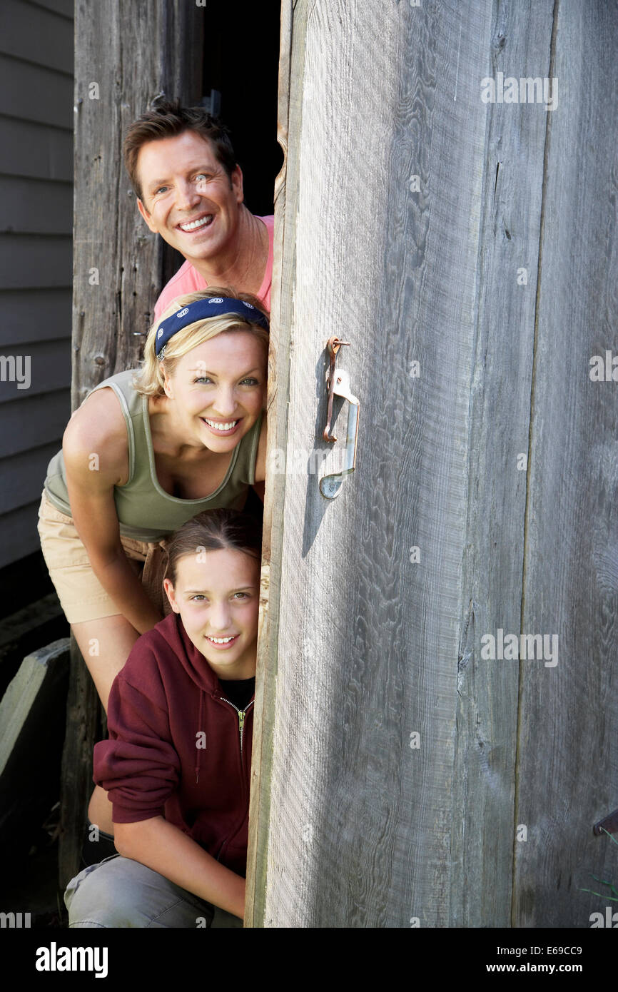 Peeking out behind door woman hi-res stock photography and images - Alamy