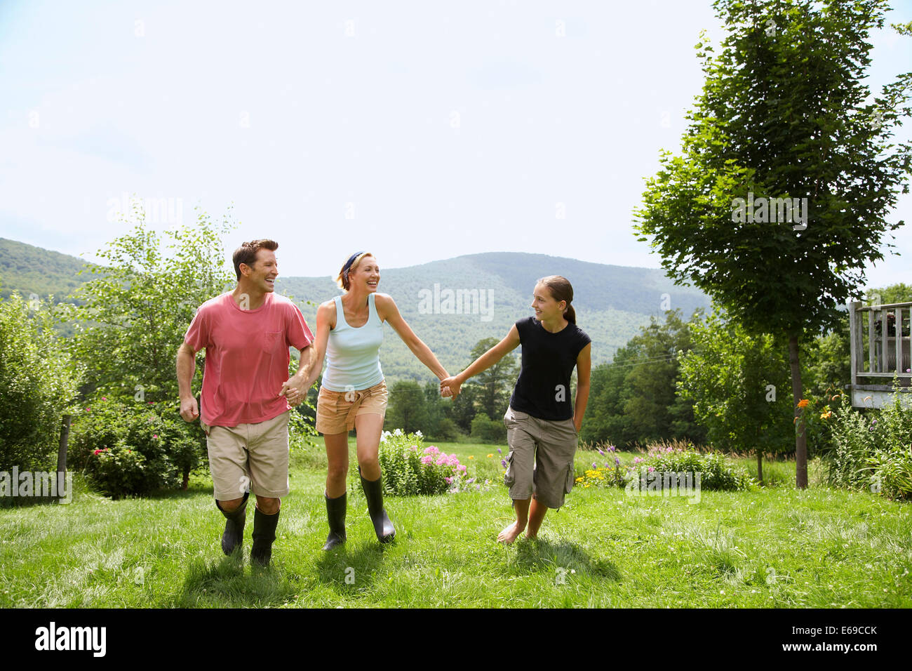 Family walking together in backyard Stock Photo - Alamy