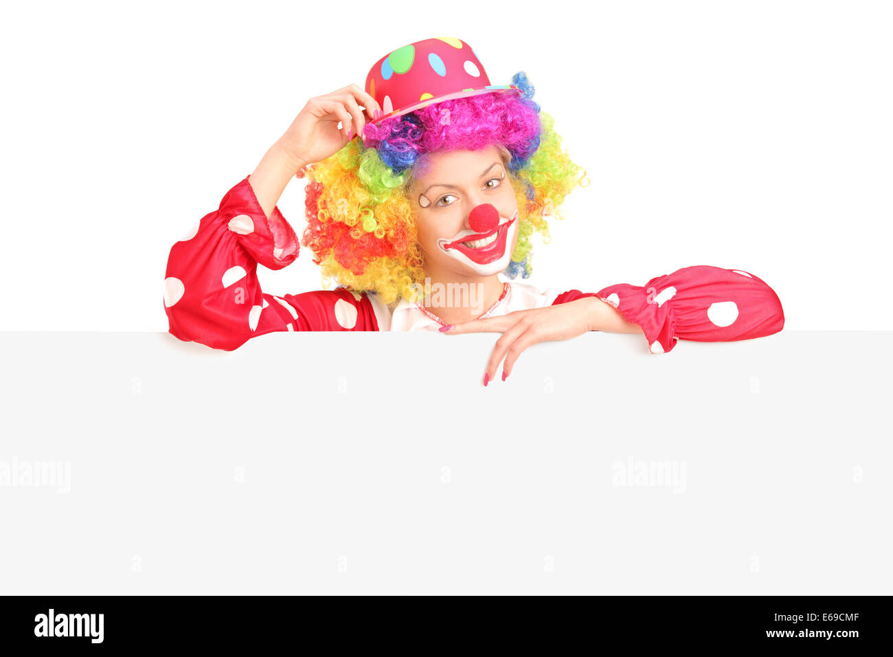 Female clown standing behind a blank panel Stock Photo - Alamy
