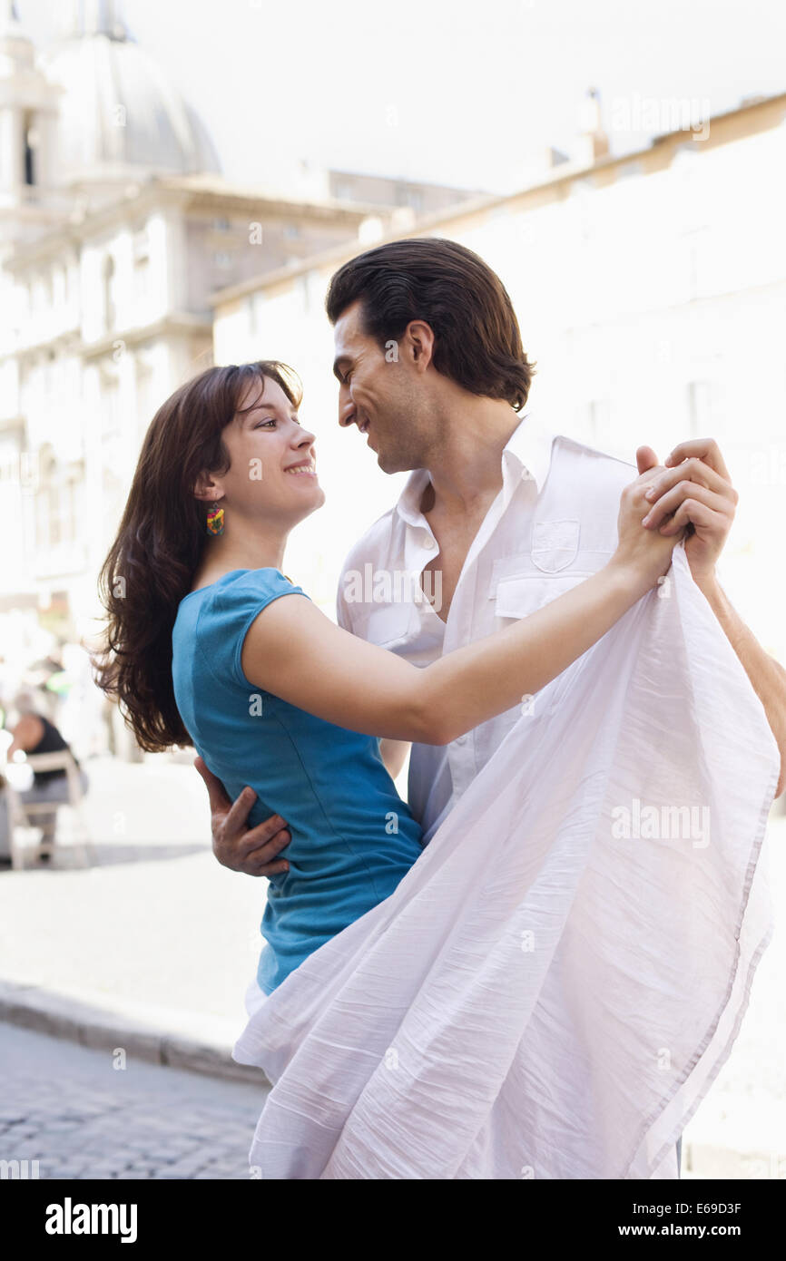 Caucasian couple dancing on city street Stock Photo - Alamy