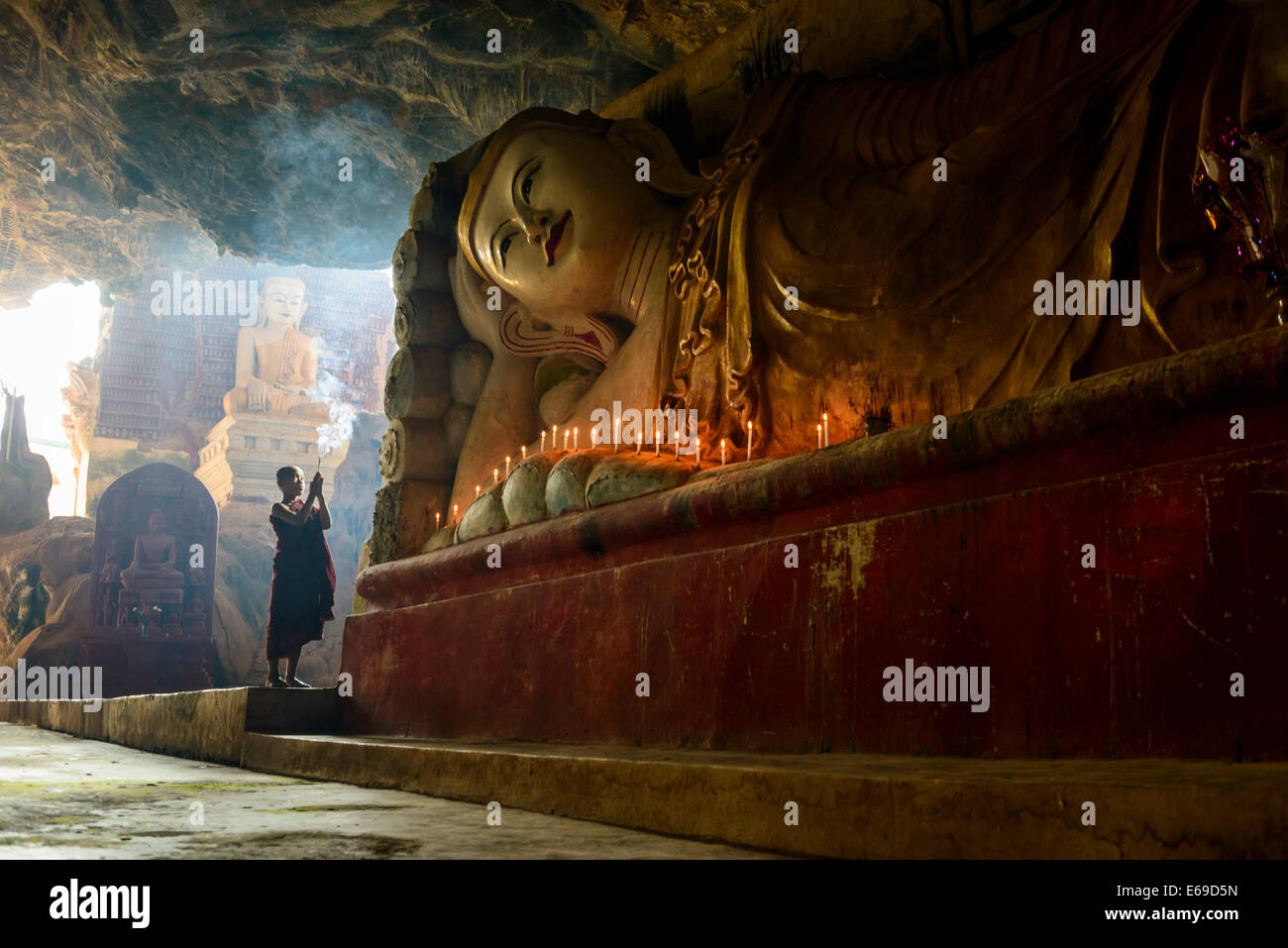 Asian monk lighting incense in temple Stock Photo - Alamy