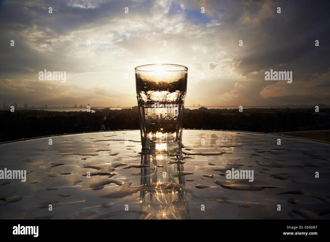 Empty glass on wet table outdoors Stock Photo - Alamy