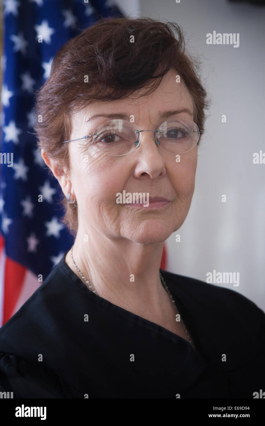 Hispanic judge posing by American flag Stock Photo - Alamy
