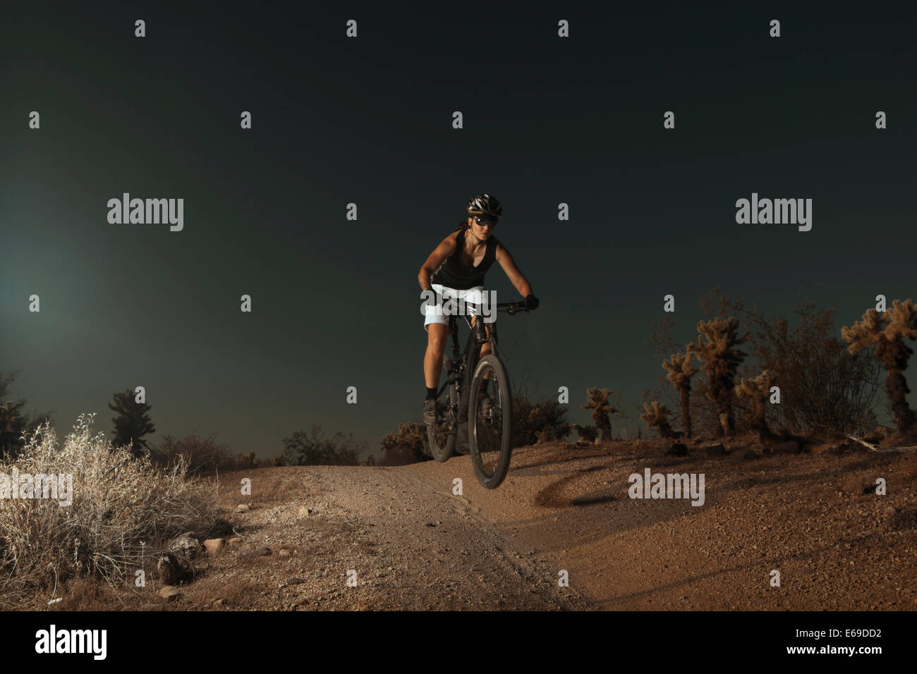 Woman riding mountain bike in desert Stock Photo - Alamy