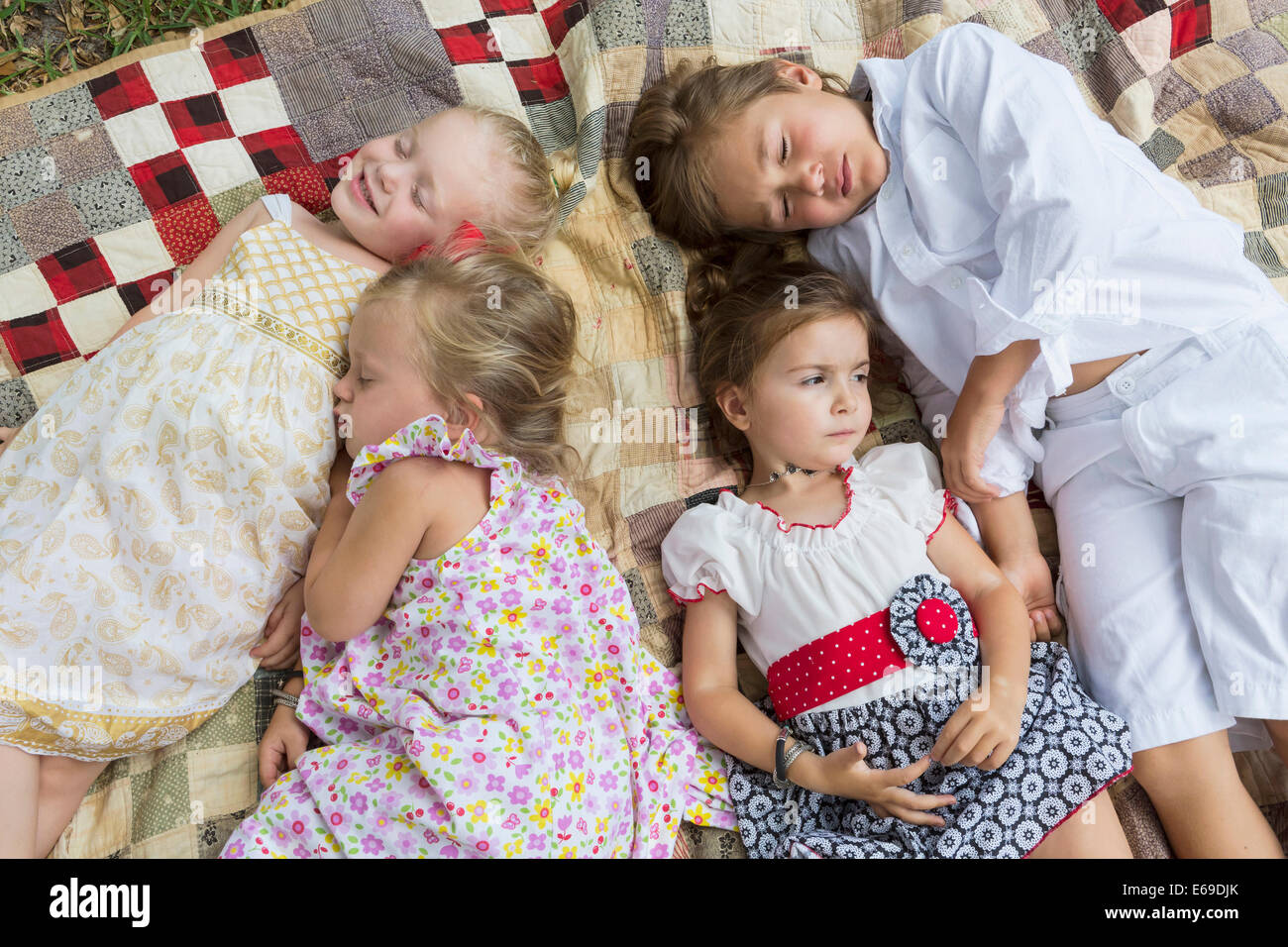 Caucasian children laying on blanket outdoors Stock Photo - Alamy