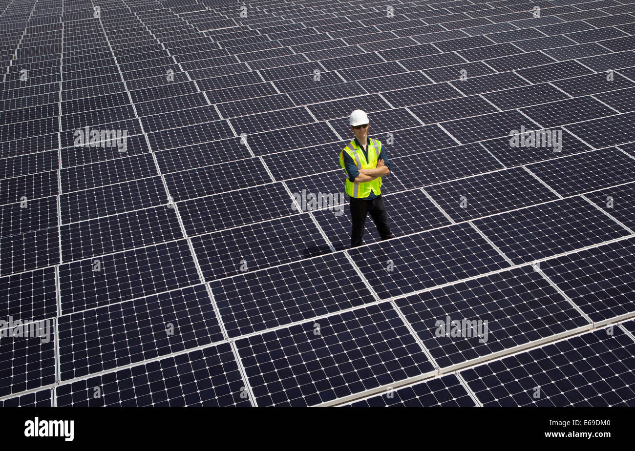 Caucasian technician smiling on solar panels Stock Photo - Alamy