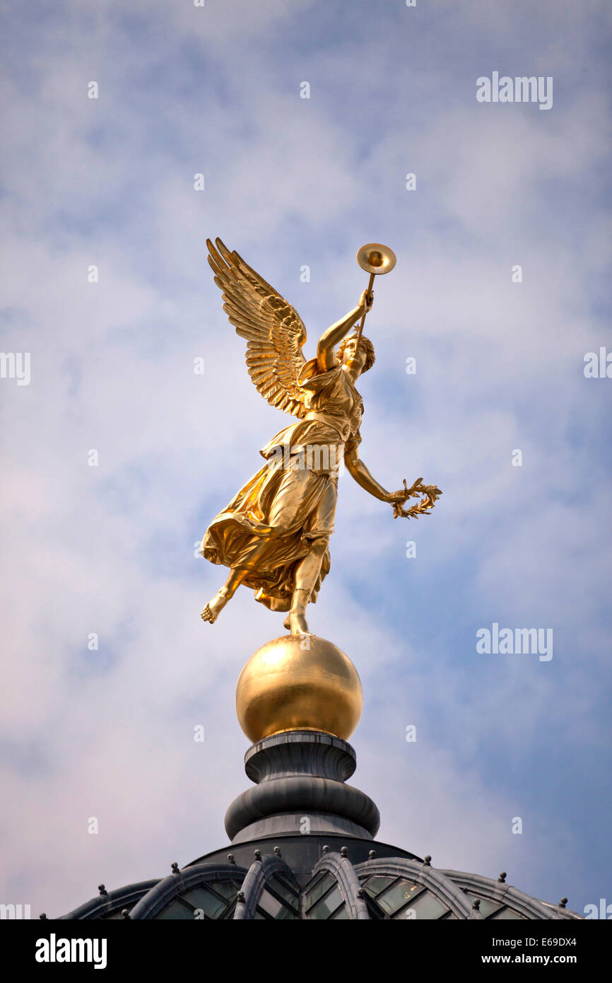 golden angel with trumpet on the dome of the Academy of Fine Arts in ...