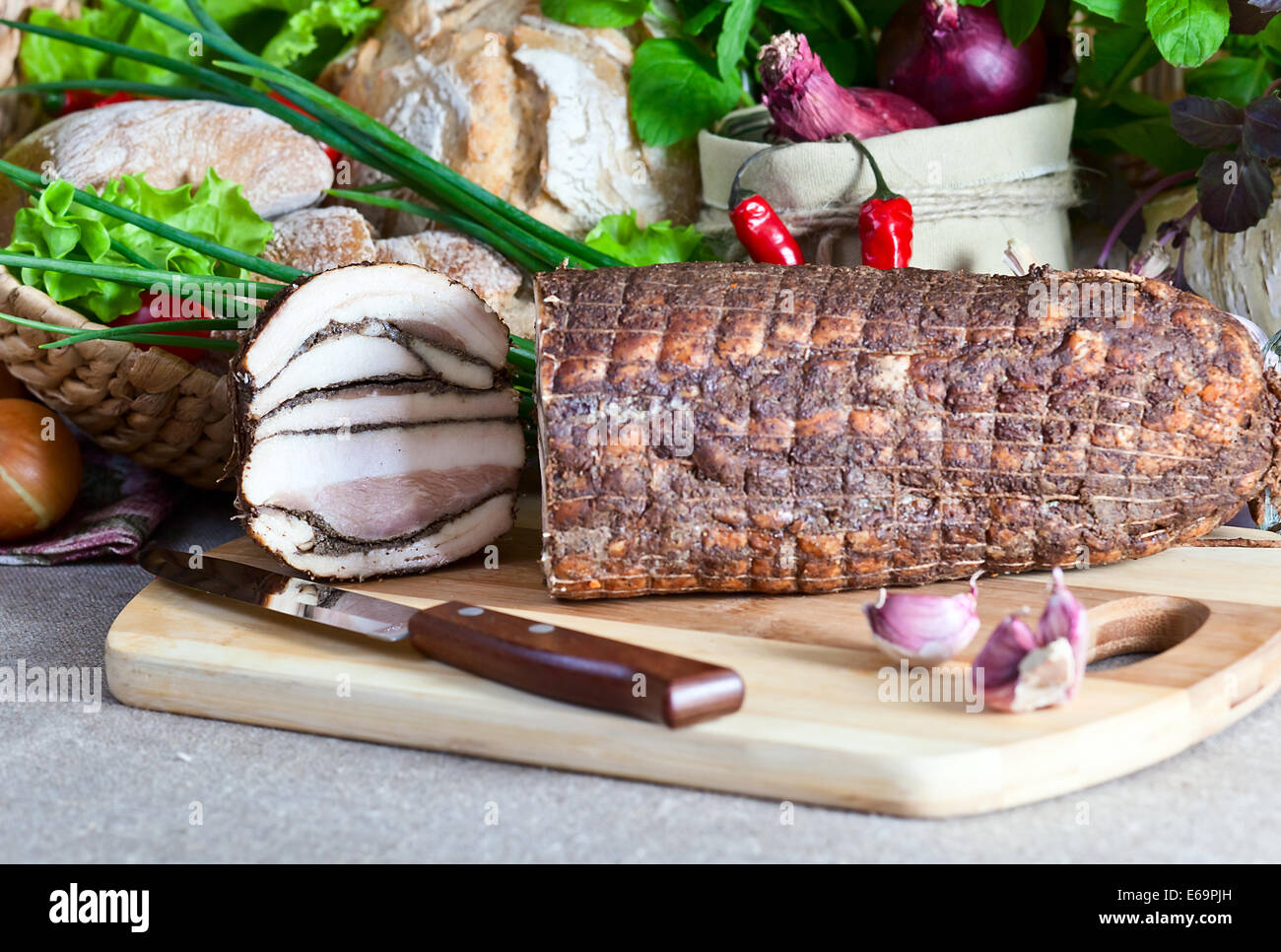 smoked meat with spices on kitchen table Stock Photo - Alamy