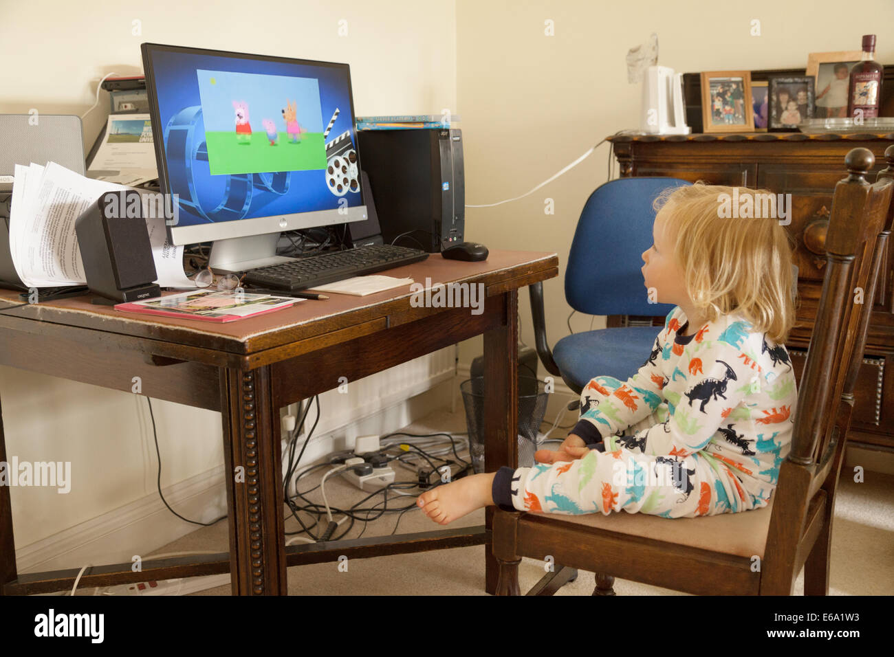A young child watching a Peppa Pig cartoon on a computer at home, Essex ...