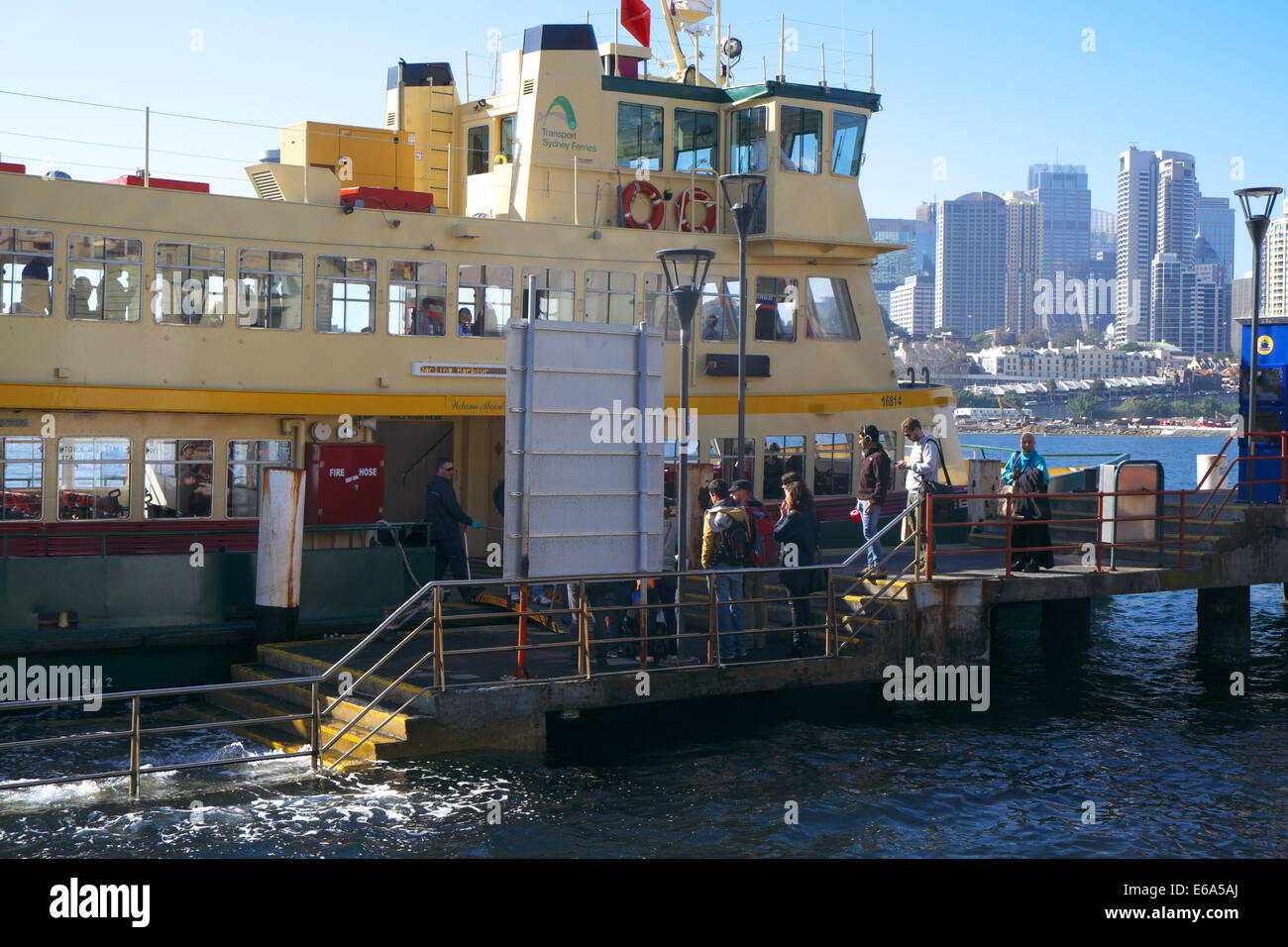 Sydney ferry meets passengers at Balmain east ferry wharf with city in ...