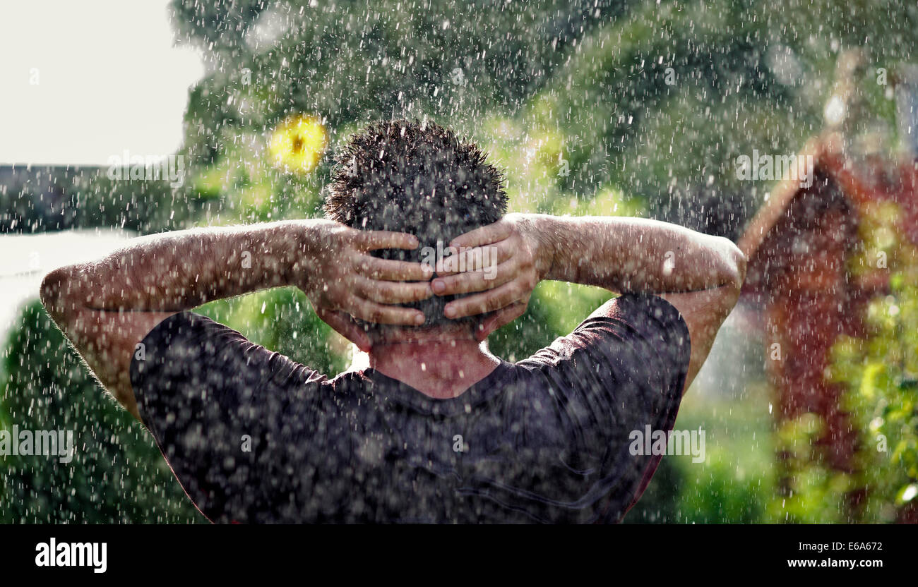 Man in the rain in the garden Stock Photo - Alamy