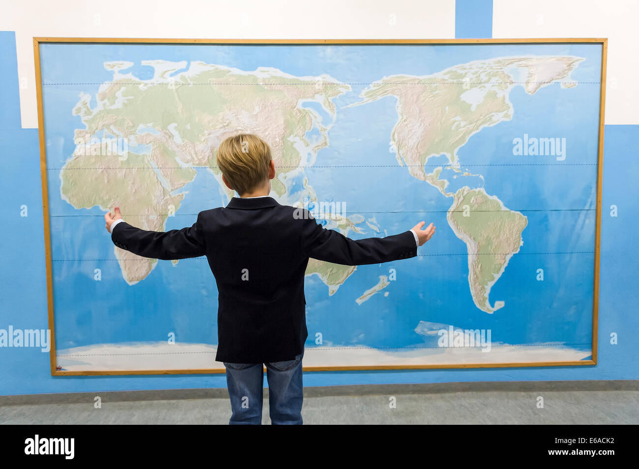 School boy standing in front of blind world map hi-res stock ...