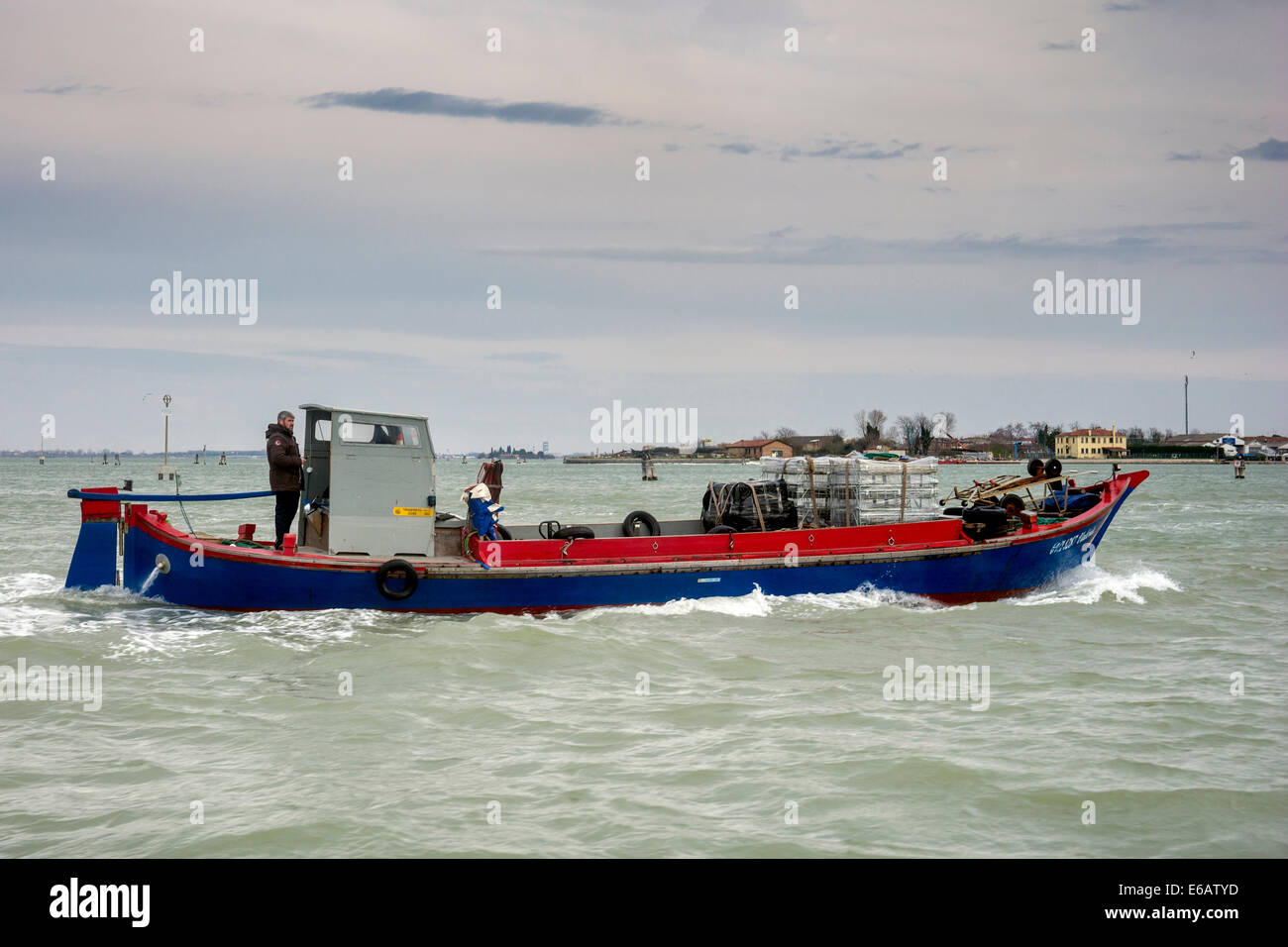 Delivery boat crossing the Lagoon in Venice Stock Photo - Alamy
