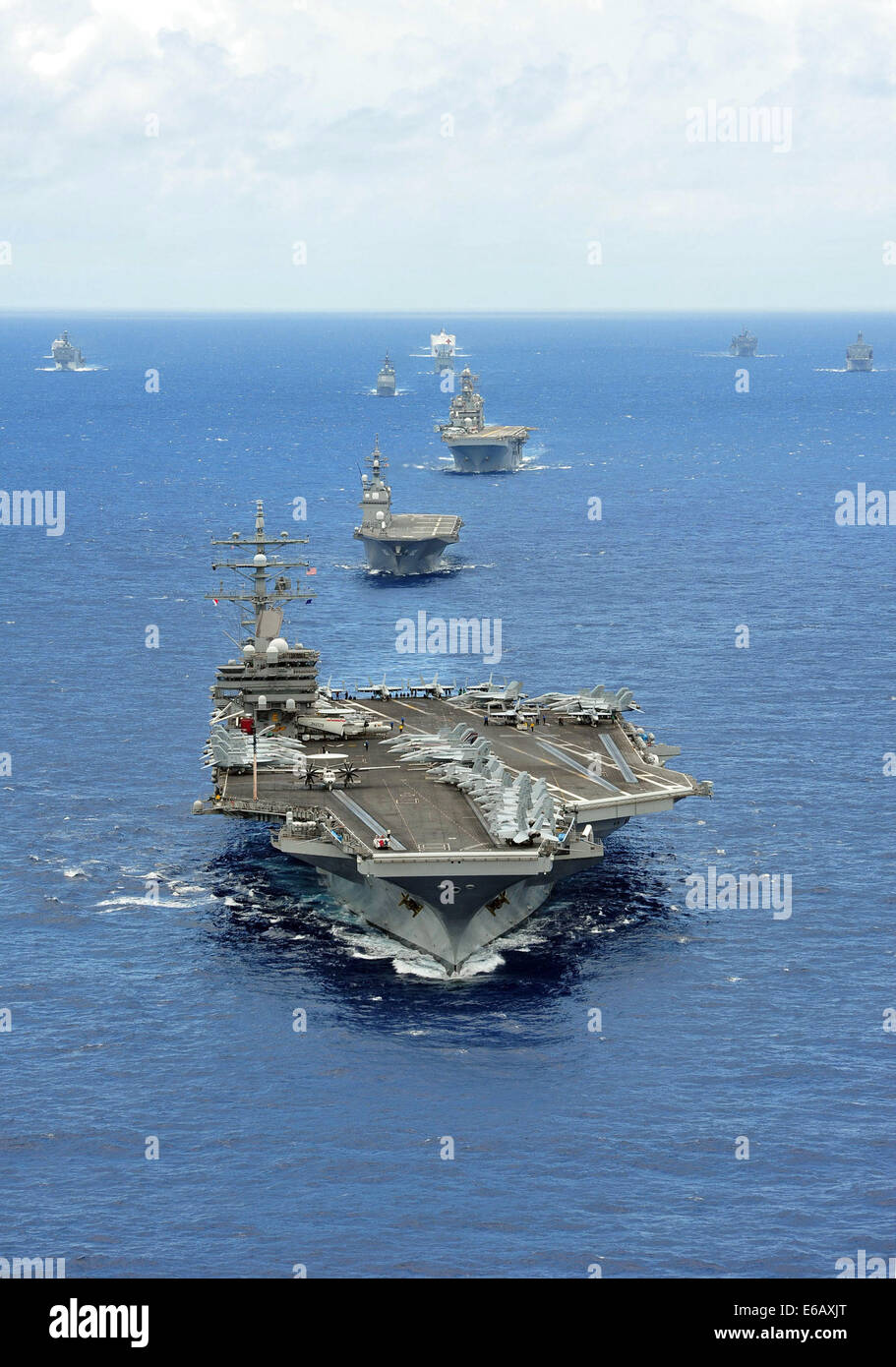 The aircraft carrier USS Ronald Reagan (CVN 76) leads a formation of ...