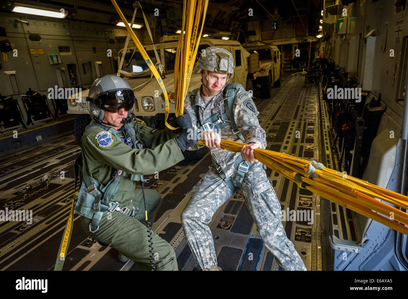A U.S. Air Force C-17 Globemaster III aircraft loadmaster, left, and an ...
