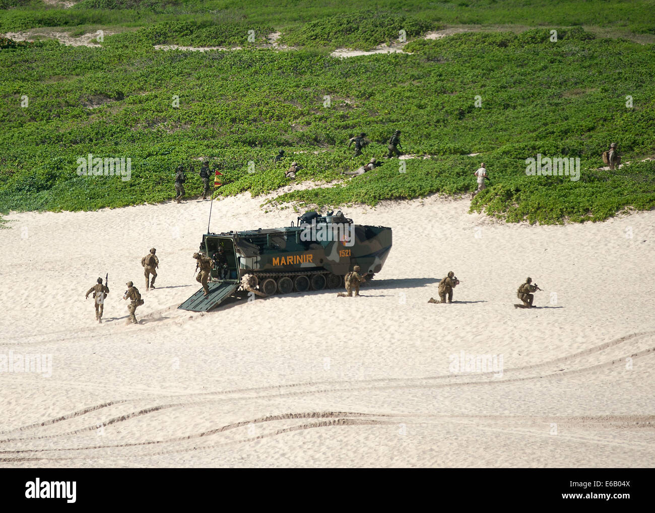Foreign service members participate in an amphibious beach assault ...