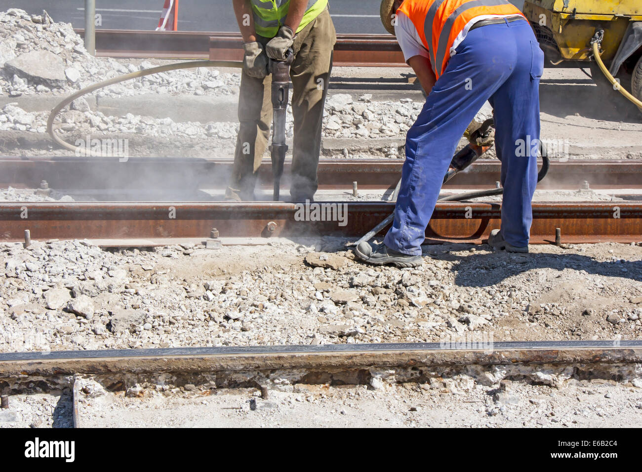 Two Workers with pneumatic hammer drill equipment breaking Concrete at ...