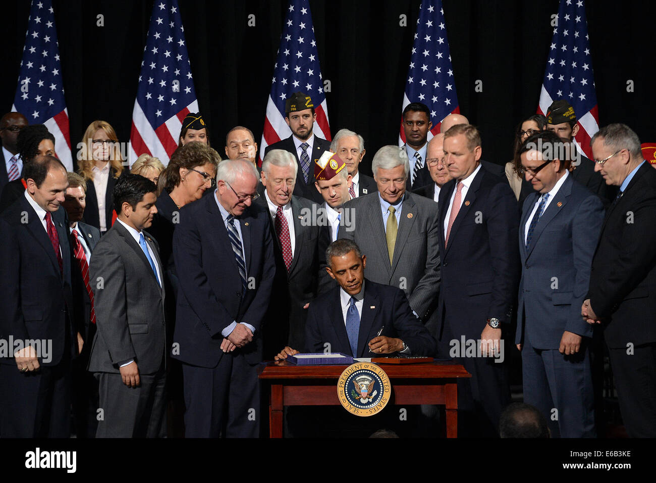 President Barack Obama, seated, signs into law a bill aimed at ...