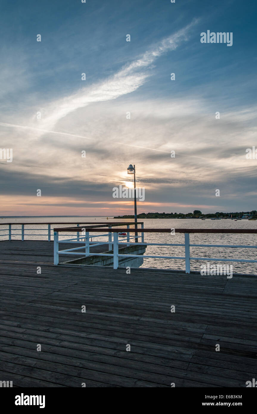 Sunset over the pier on the water Stock Photo - Alamy