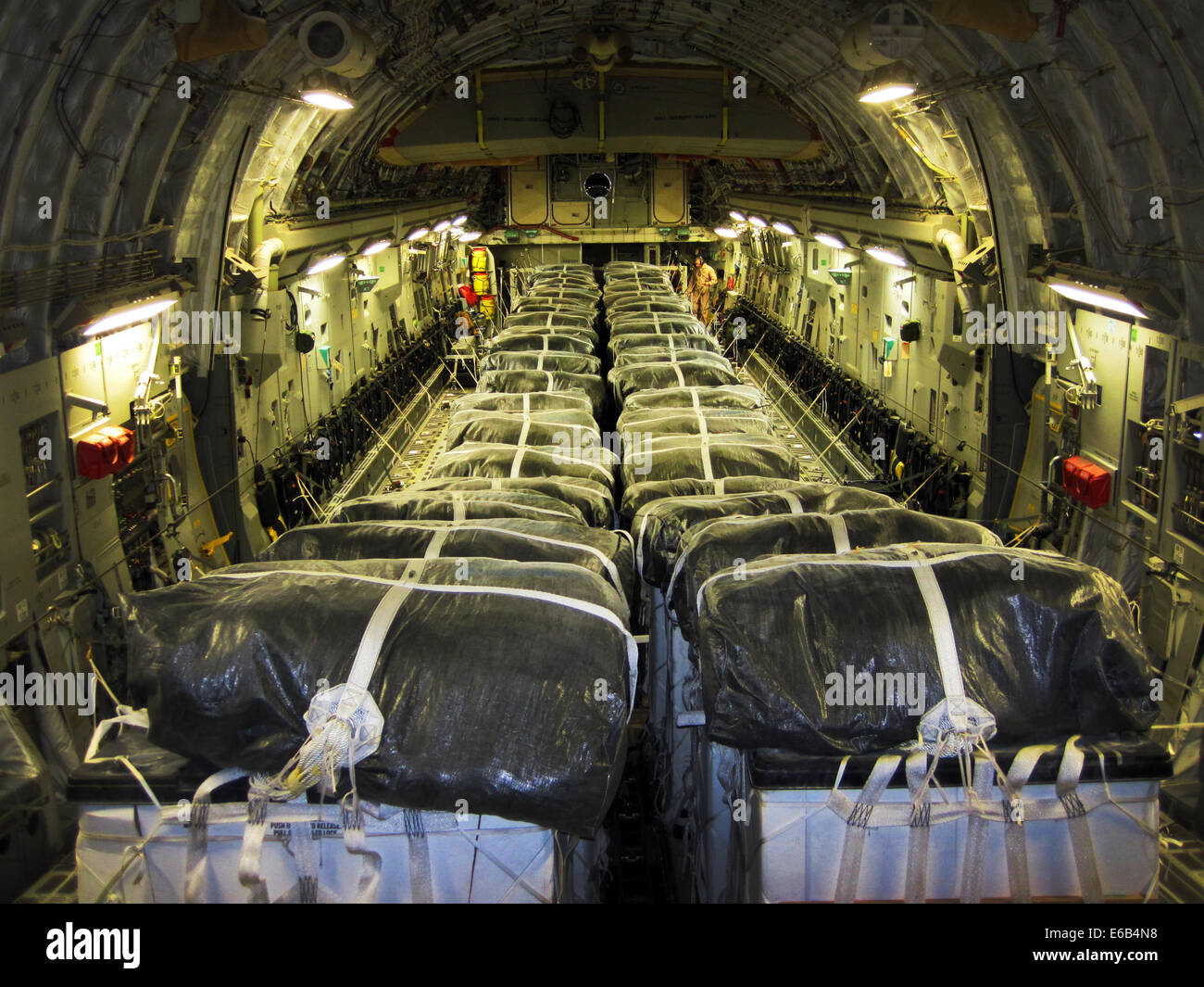 Pallets of bottled water are loaded aboard a U.S. Air Force C-17 ...