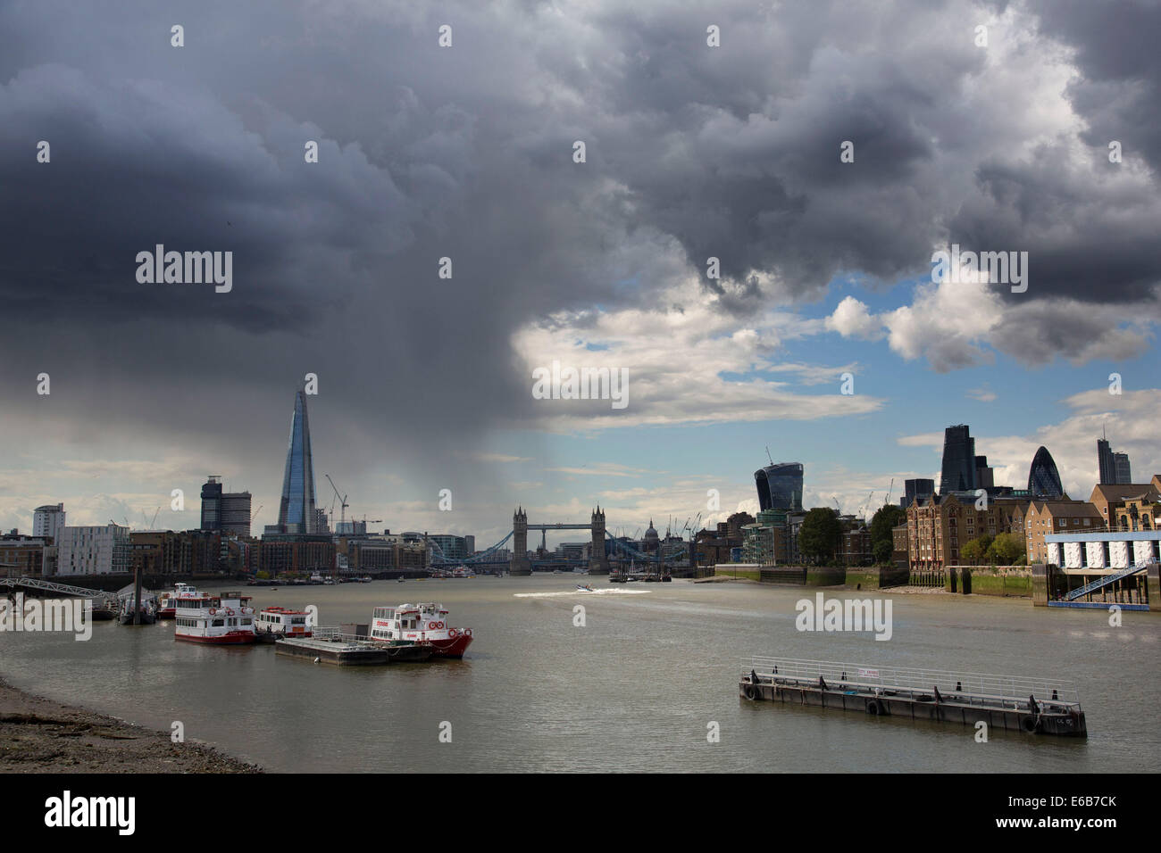 London, UK. 19th August, 2014. A rain shower falls over The Shard as ...