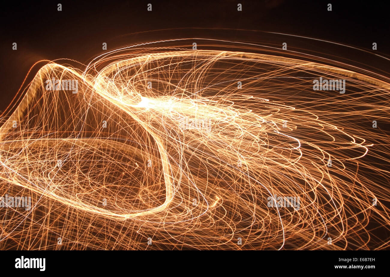 a swinging colorful pyrotechnic effect in dark back Stock Photo - Alamy