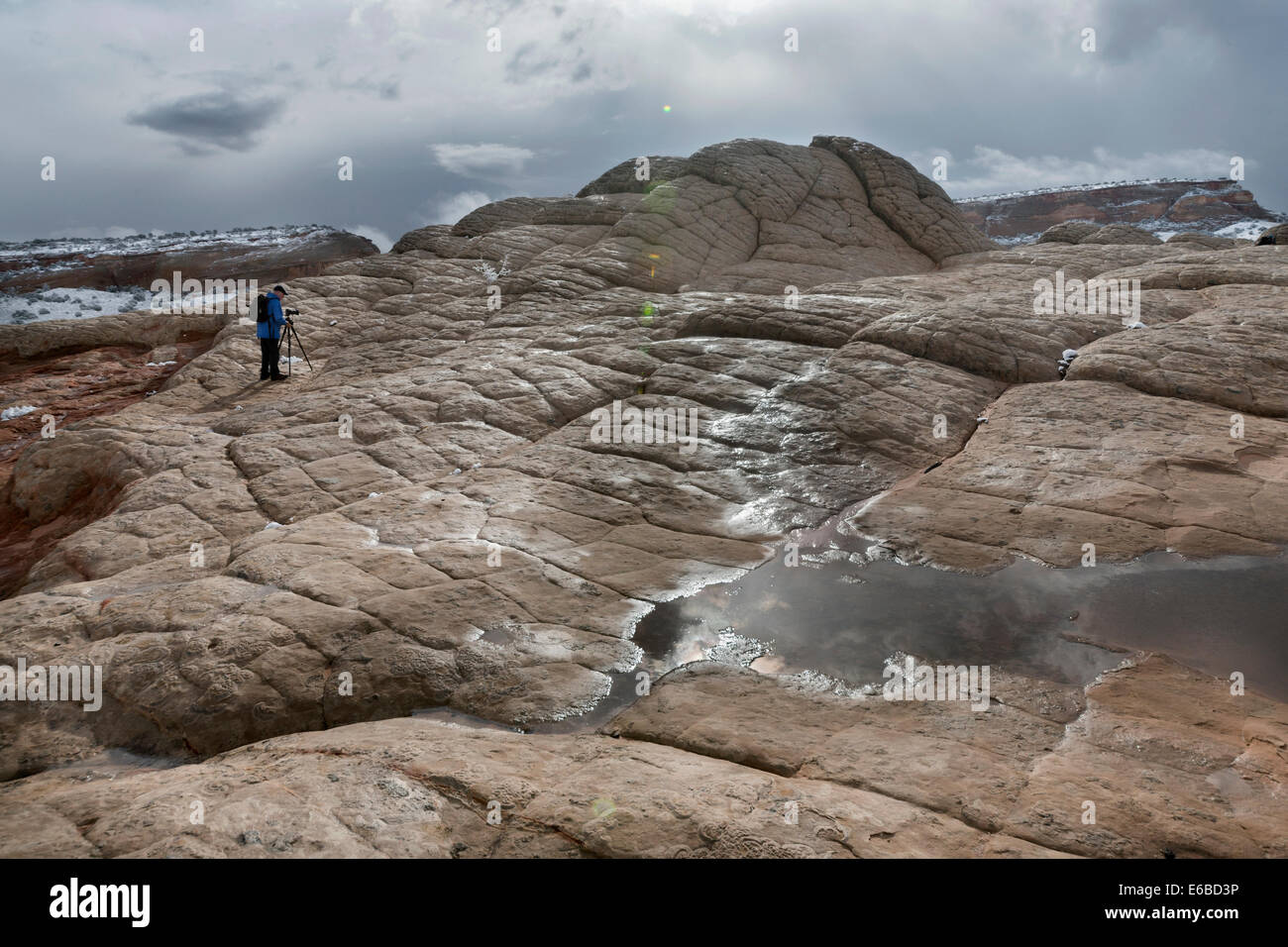 Tessellated rocks with photographer, snow melt and reflections, White ...