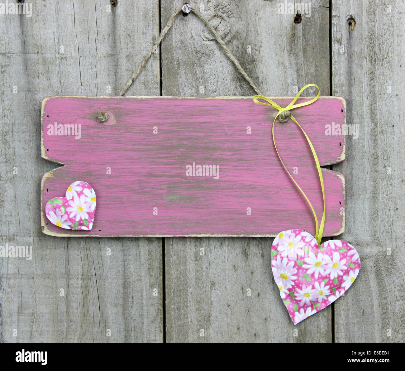 Blank pink rustic sign with floral hearts with daisies hanging on ...