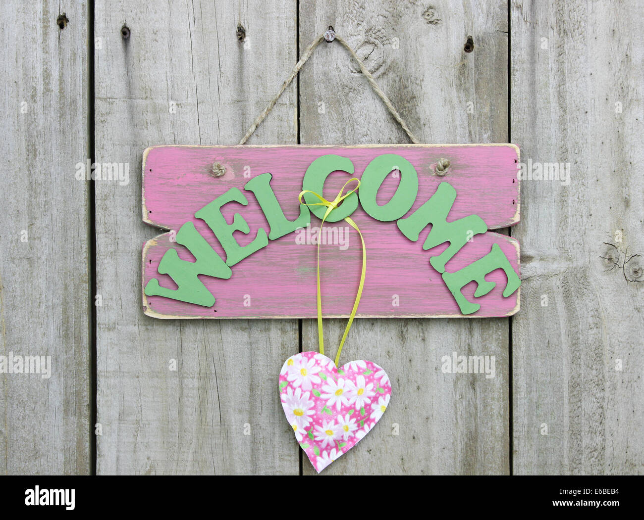 Rustic pink welcome sign with floral heart with daisies hanging on ...