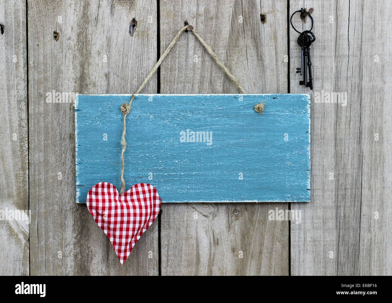 Blank antique blue sign with red checkered heart and iron keys hanging ...