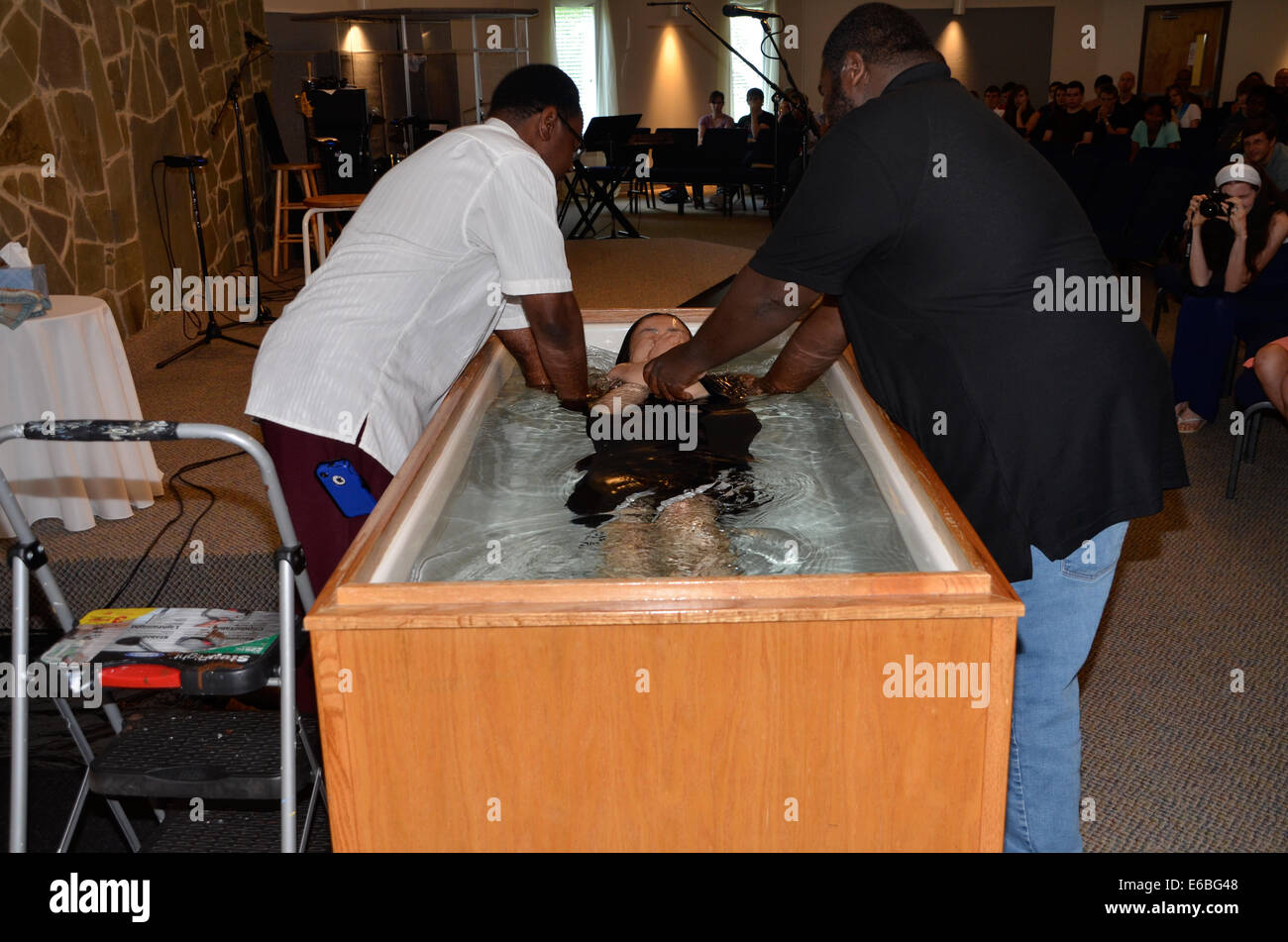 Young women gets baptized Stock Photo - Alamy