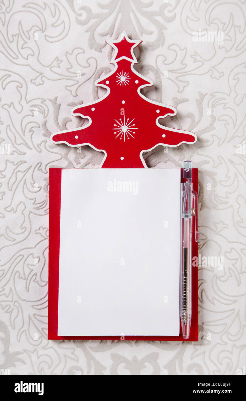 Christmas wishlist: white and red writing pad with a tree of wood Stock ...