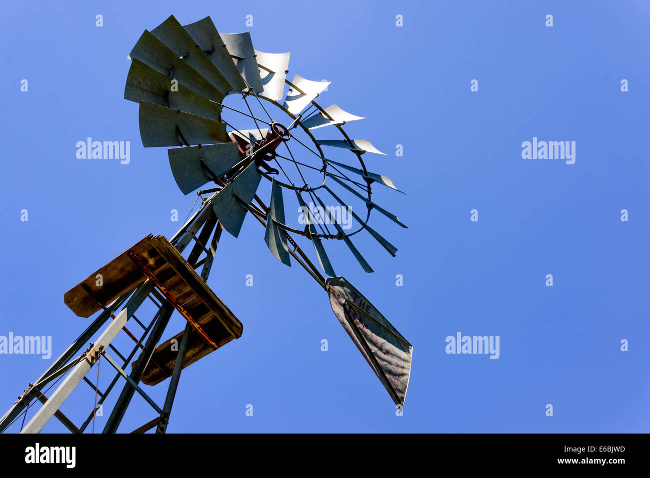wind turbine at a well pump with a blue sky background Stock Photo - Alamy