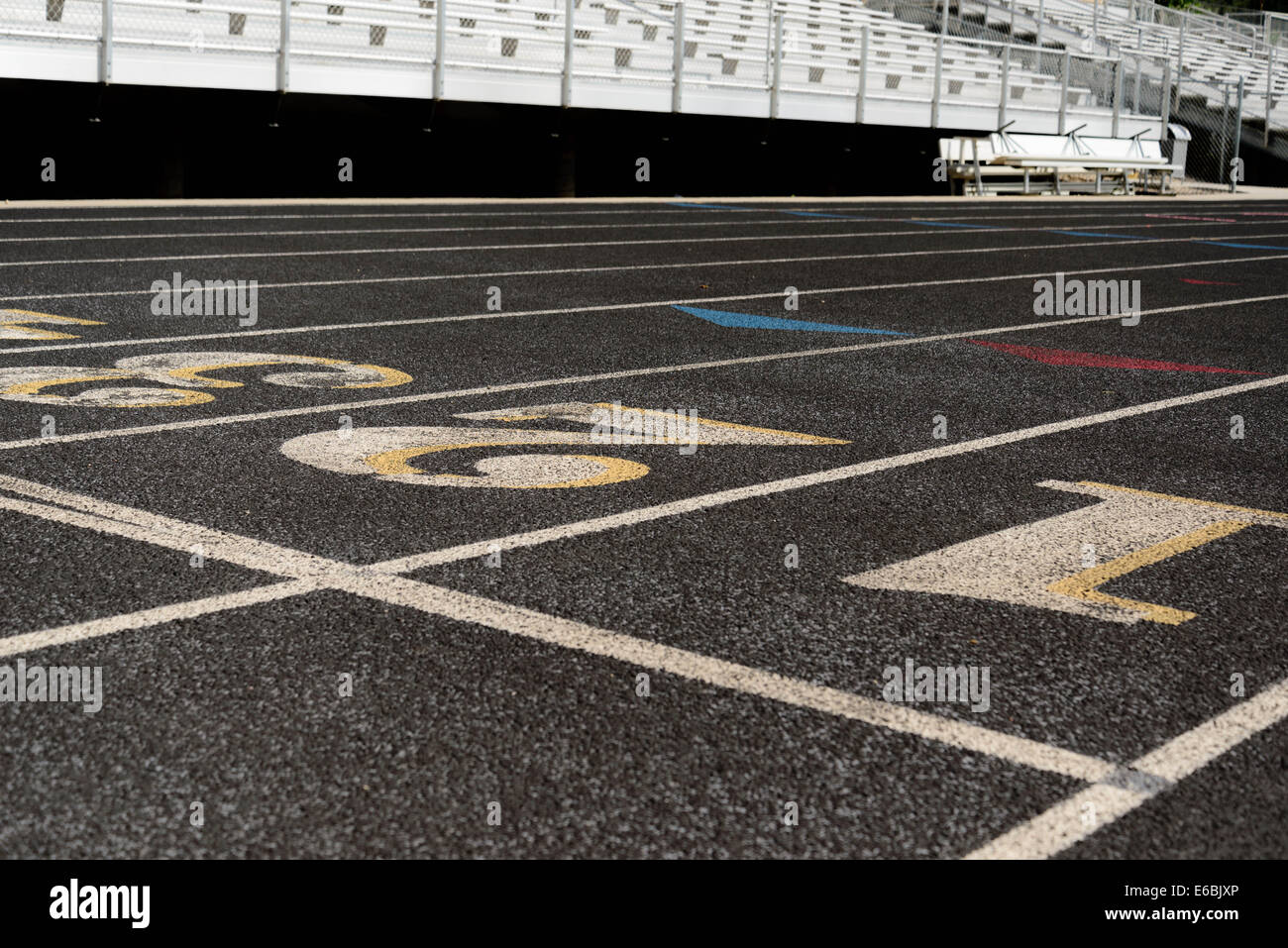 outdoor black running track with painted lane lines Stock Photo - Alamy