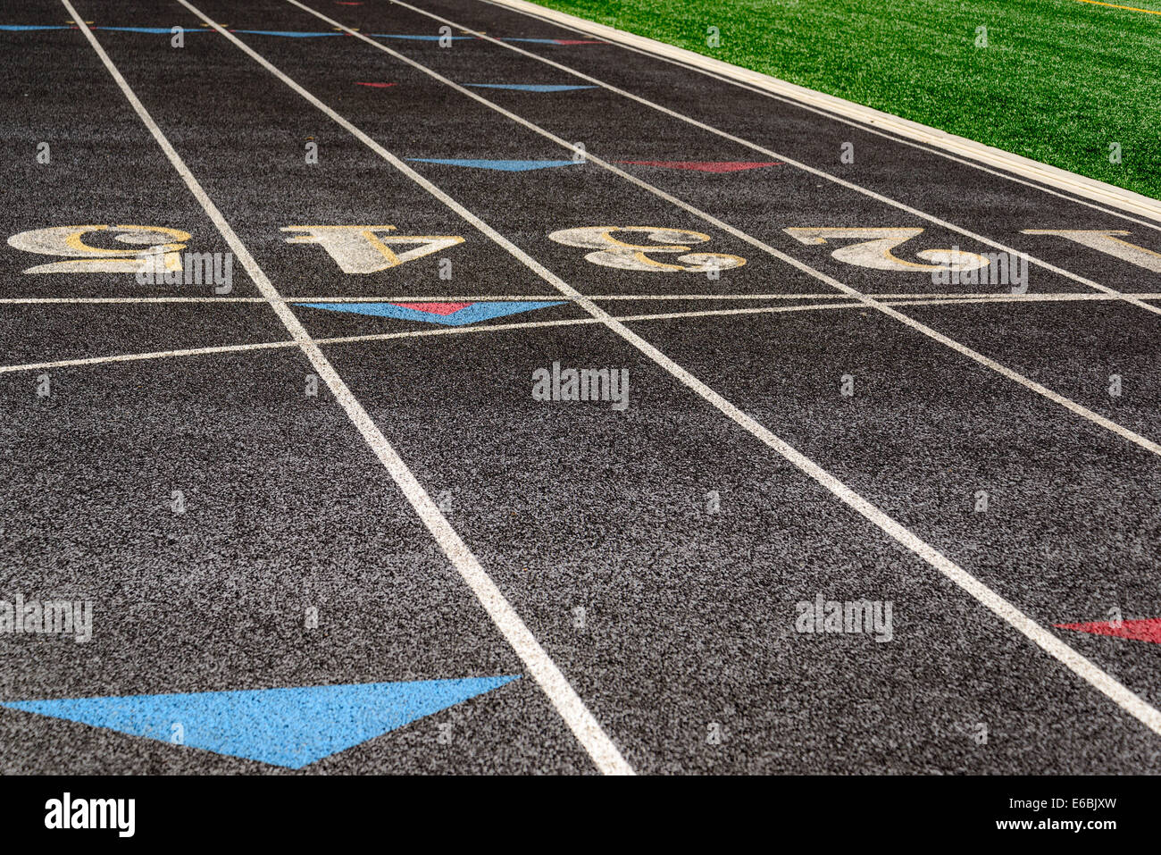 outdoor black running track with painted lane lines Stock Photo - Alamy